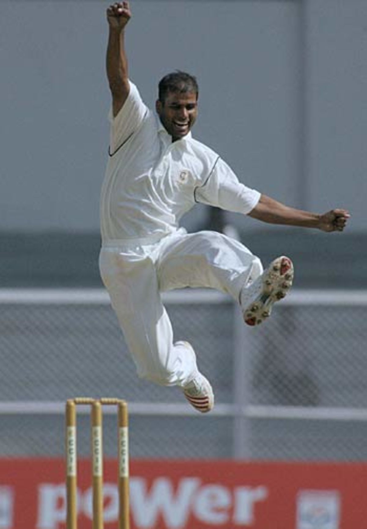 Munis Ansari celebrates taking the wicket of Andrew Flintoff ...