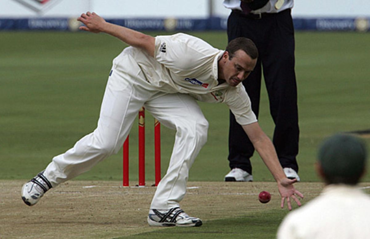 Stuart Clark stoops to stop the ball | ESPNcricinfo.com