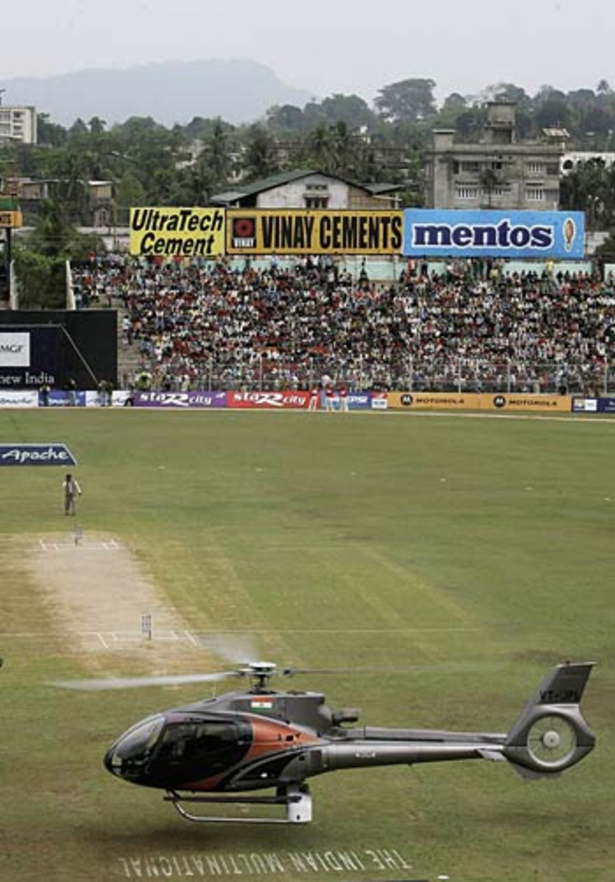 A helicopter tries to dry the pitch at a waterlogged Nehru Stadium ...