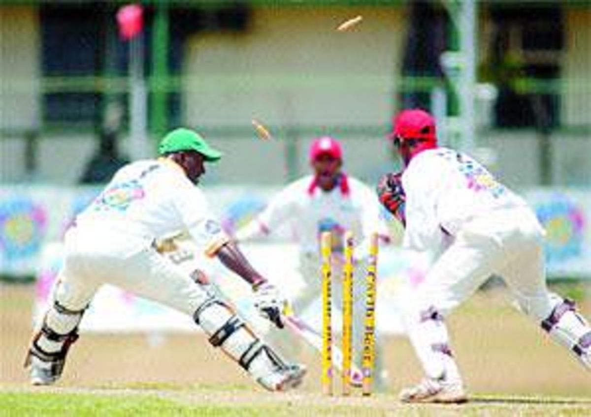 Rawl Lewis is deftly stumped by Denesh Ramdin to end his brief cameo of ...