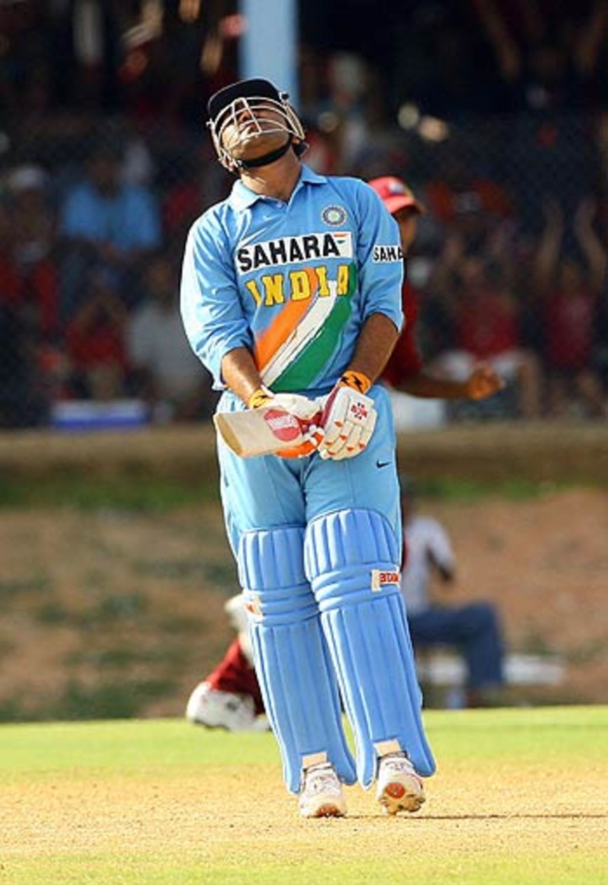 West Indies players celebrate the fall of Virender Sehwag ...