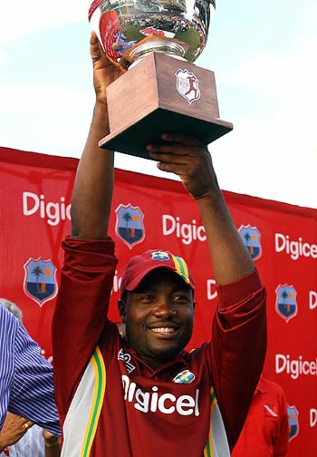 A victorious Brian Lara holds the ODI trophy for all of Trinidad to see ...