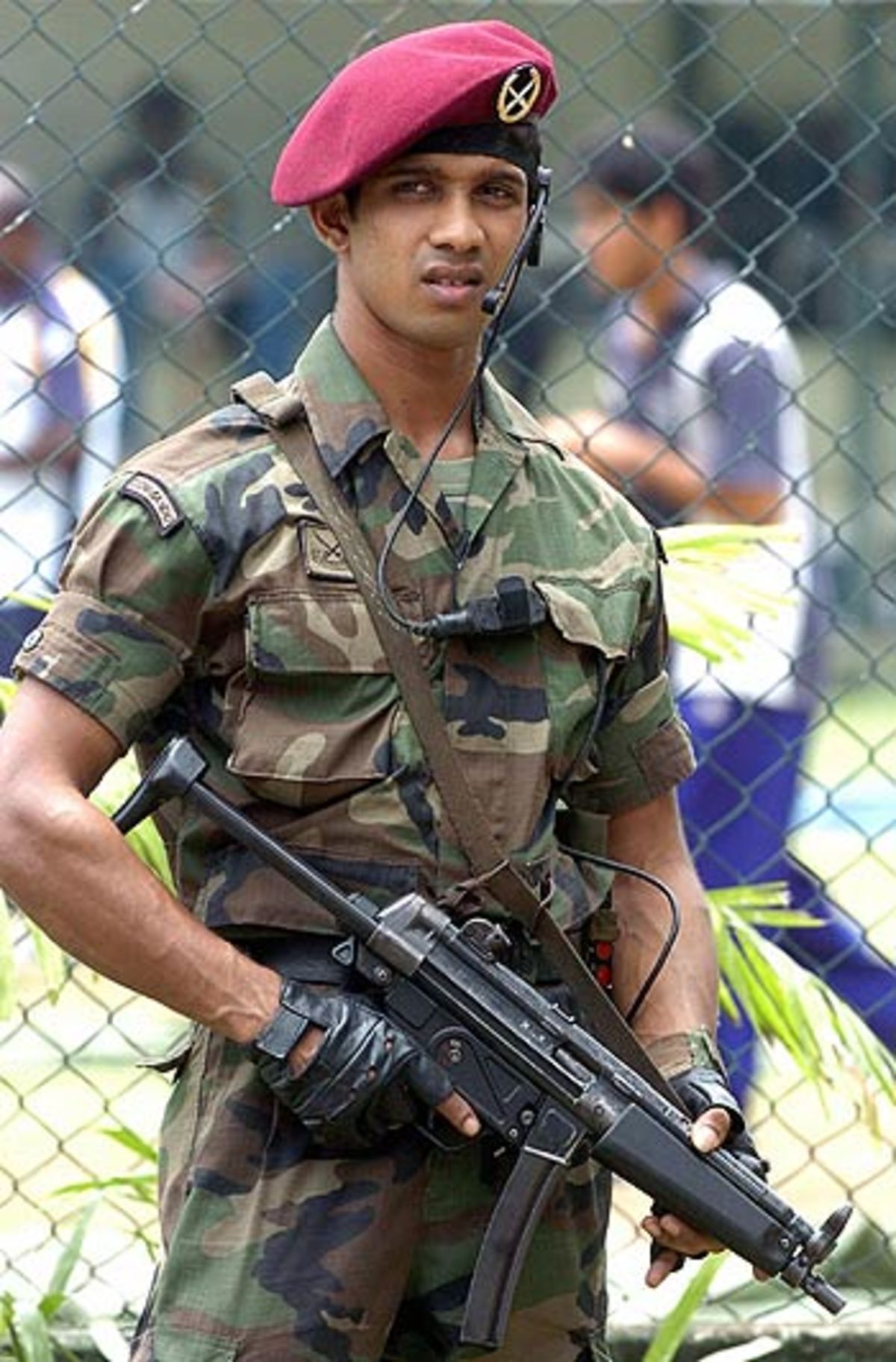 A commando stands guard as the Sri Lankans arrive for practice at the ...