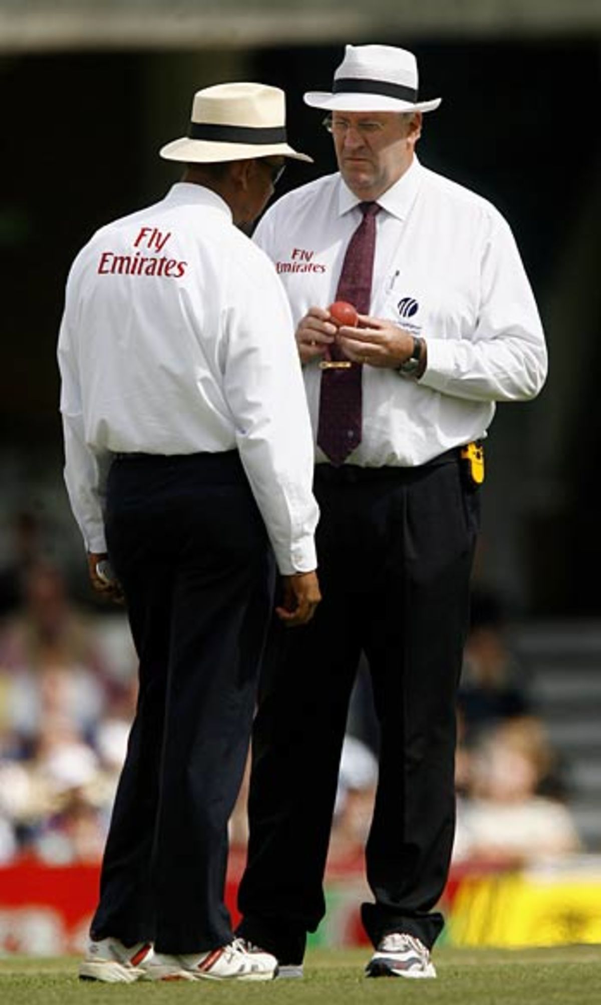 The Pakistan players huddle around the umpires as the ball is changed ...