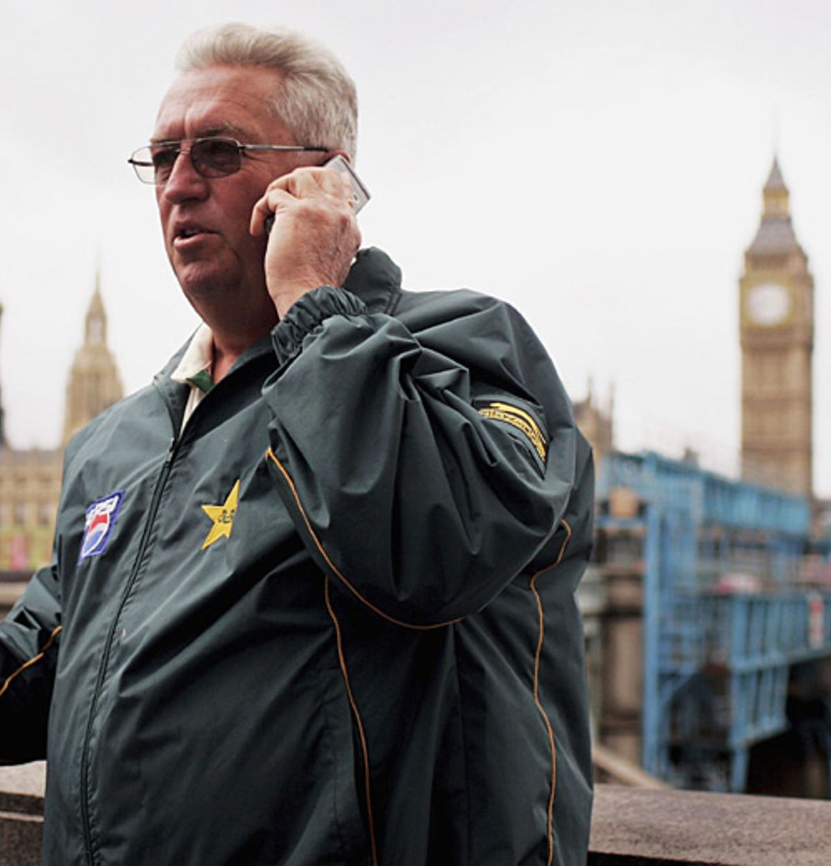 Bob Woolmer chats on the phone by the River Thames at Westminster ...