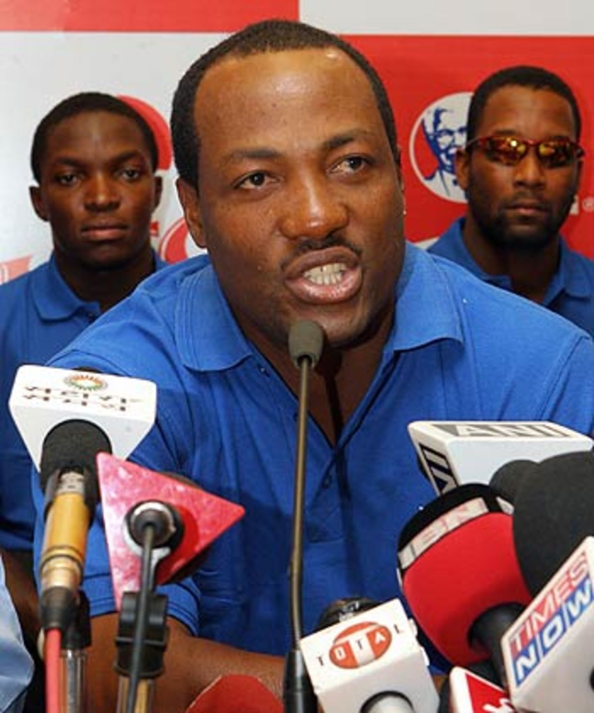 Brian Lara displays an autographed bat by all West Indies players in a ...