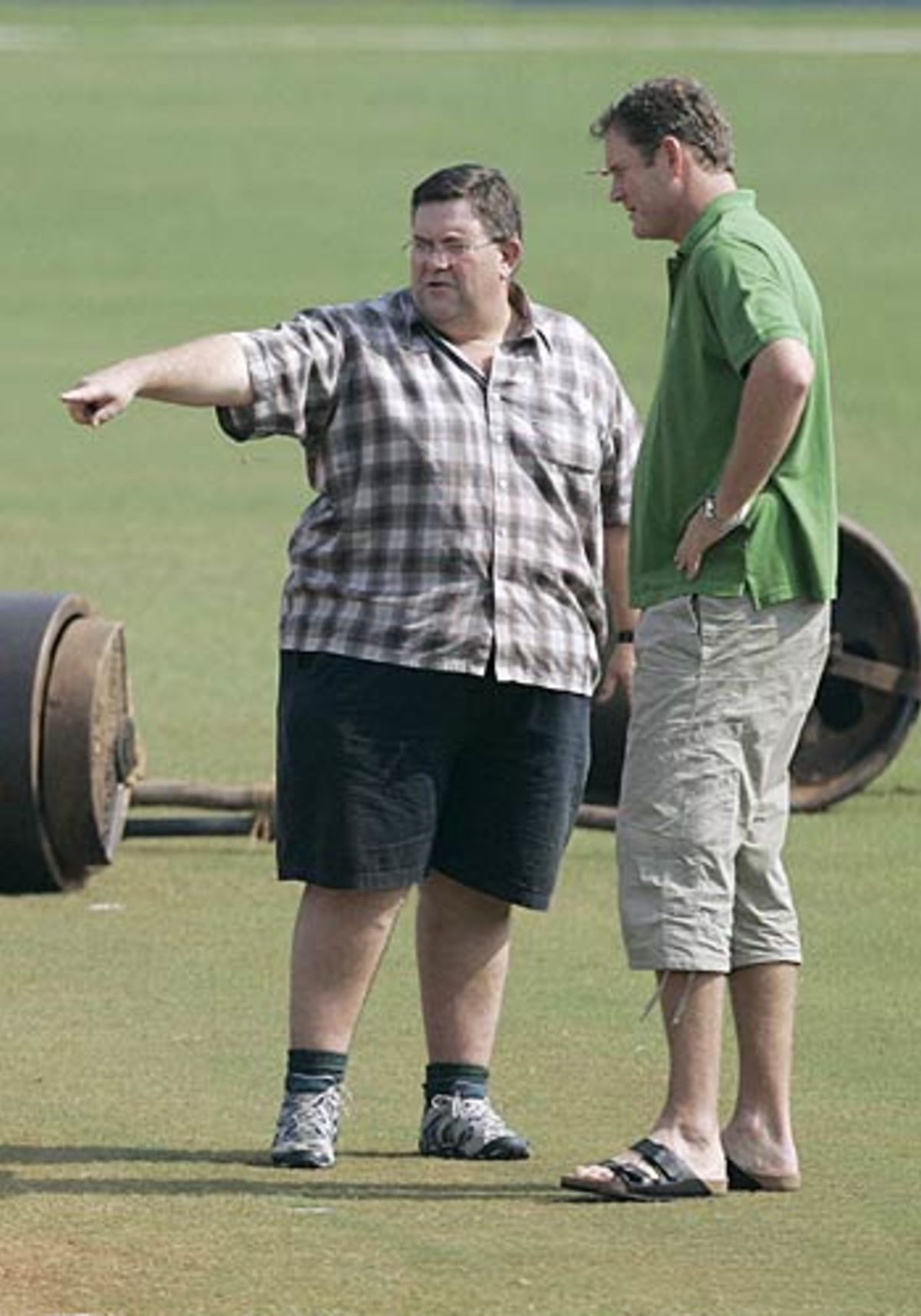Tom Moody inspects the pitch while ICC grounds consultant Andy Atkinson ...