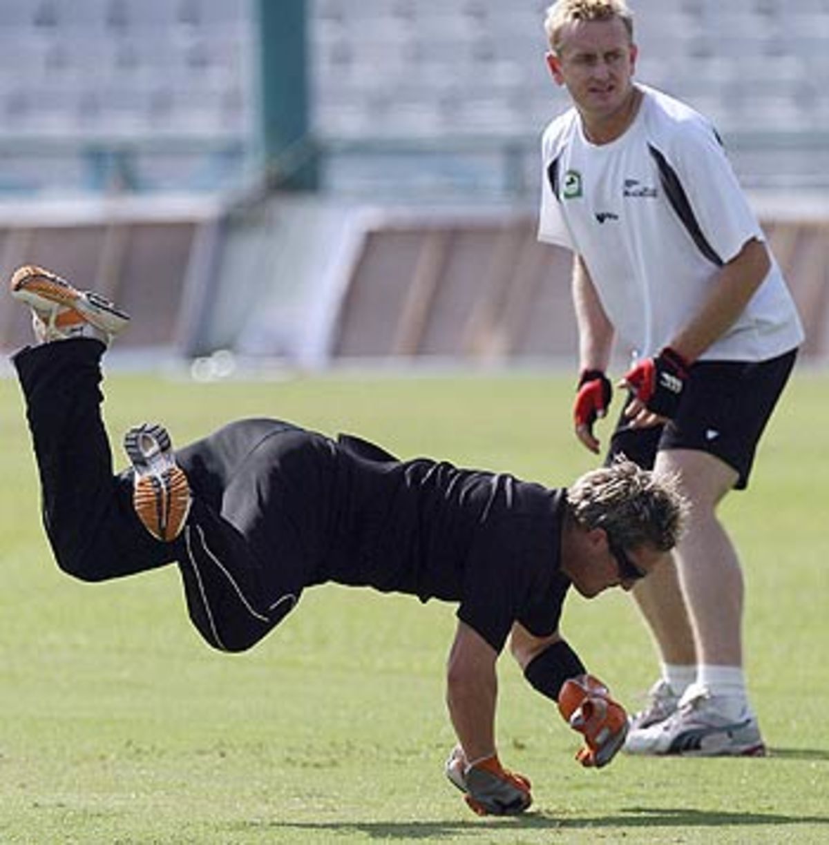Brendan McCullum takes one inches off the ground as Scott Styris looks ...