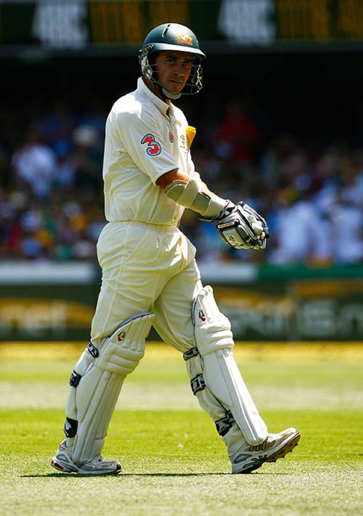 Justin Langer makes his way back to the pavilion after being caught for ...