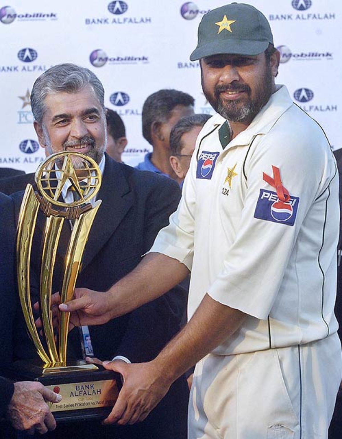 Inzamam-ul-Haq receives the series trophy from Nasim Ashraf, the ...