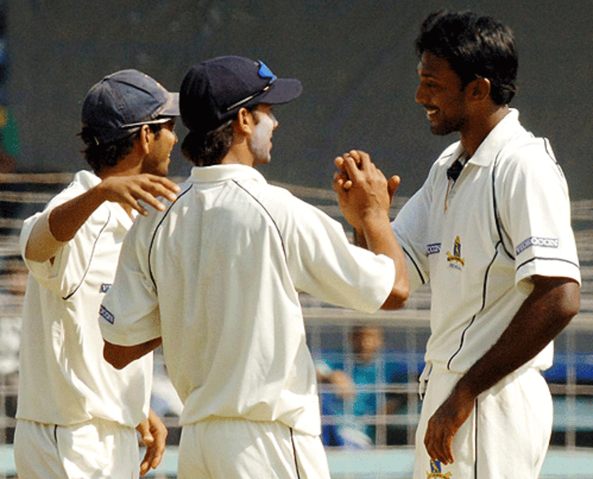 Bengal team-mates congratulate Saurasish Lahiri for getting the wicket ...