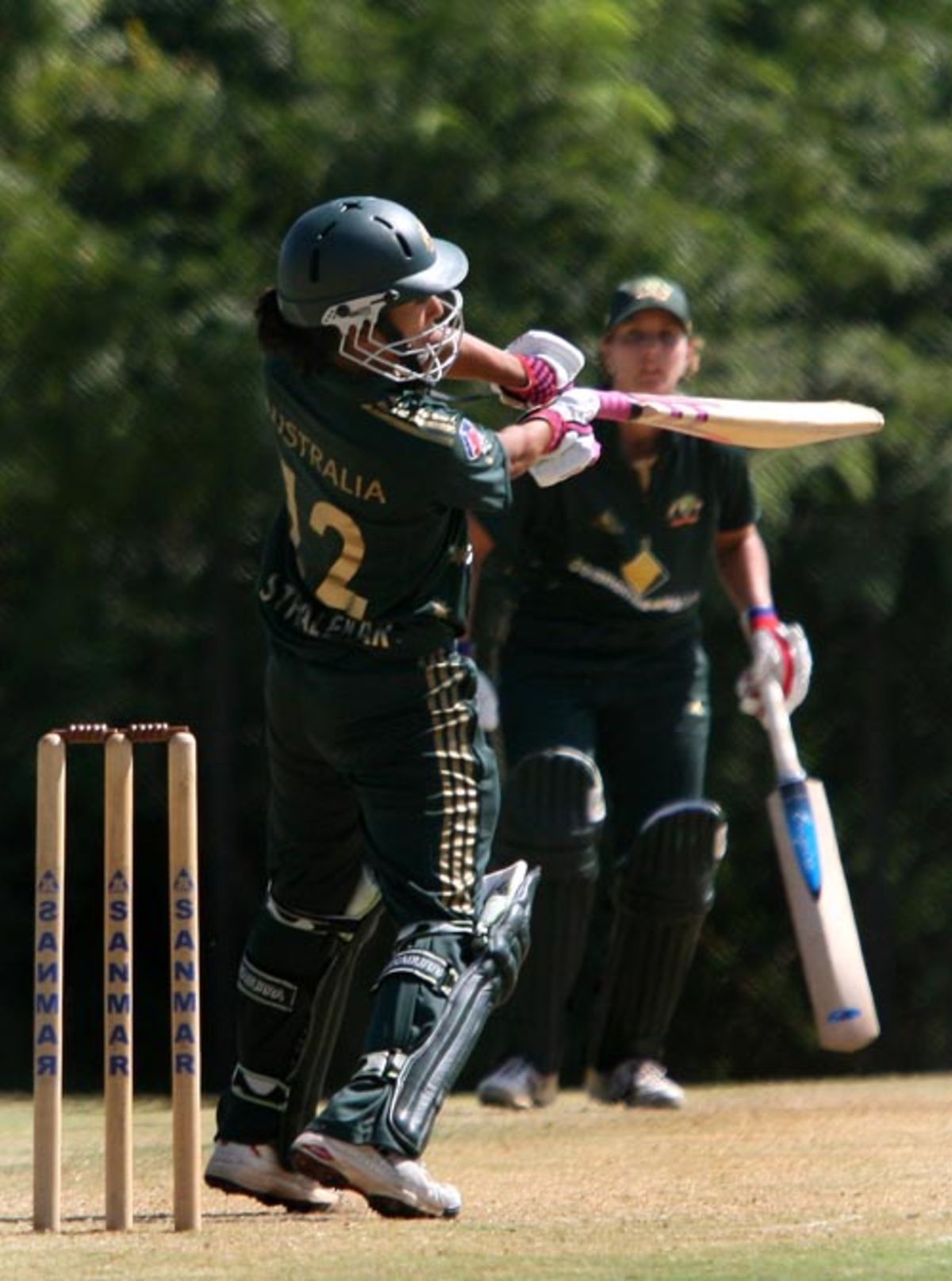 Maria Fahey (left) and Helen Watson of New Zealand cross over for a ...