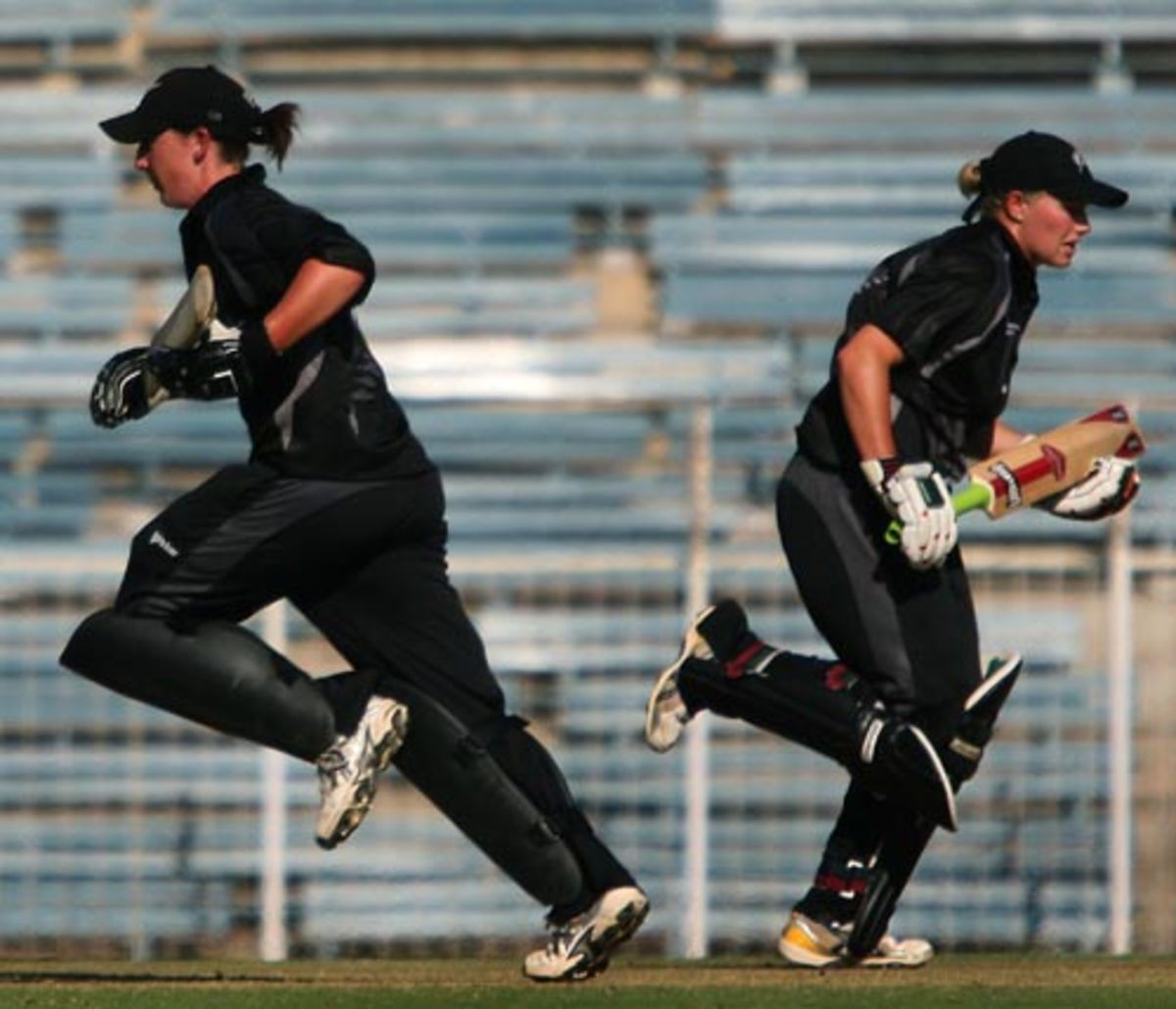 Maria Fahey (left) and Helen Watson of New Zealand cross over for a ...