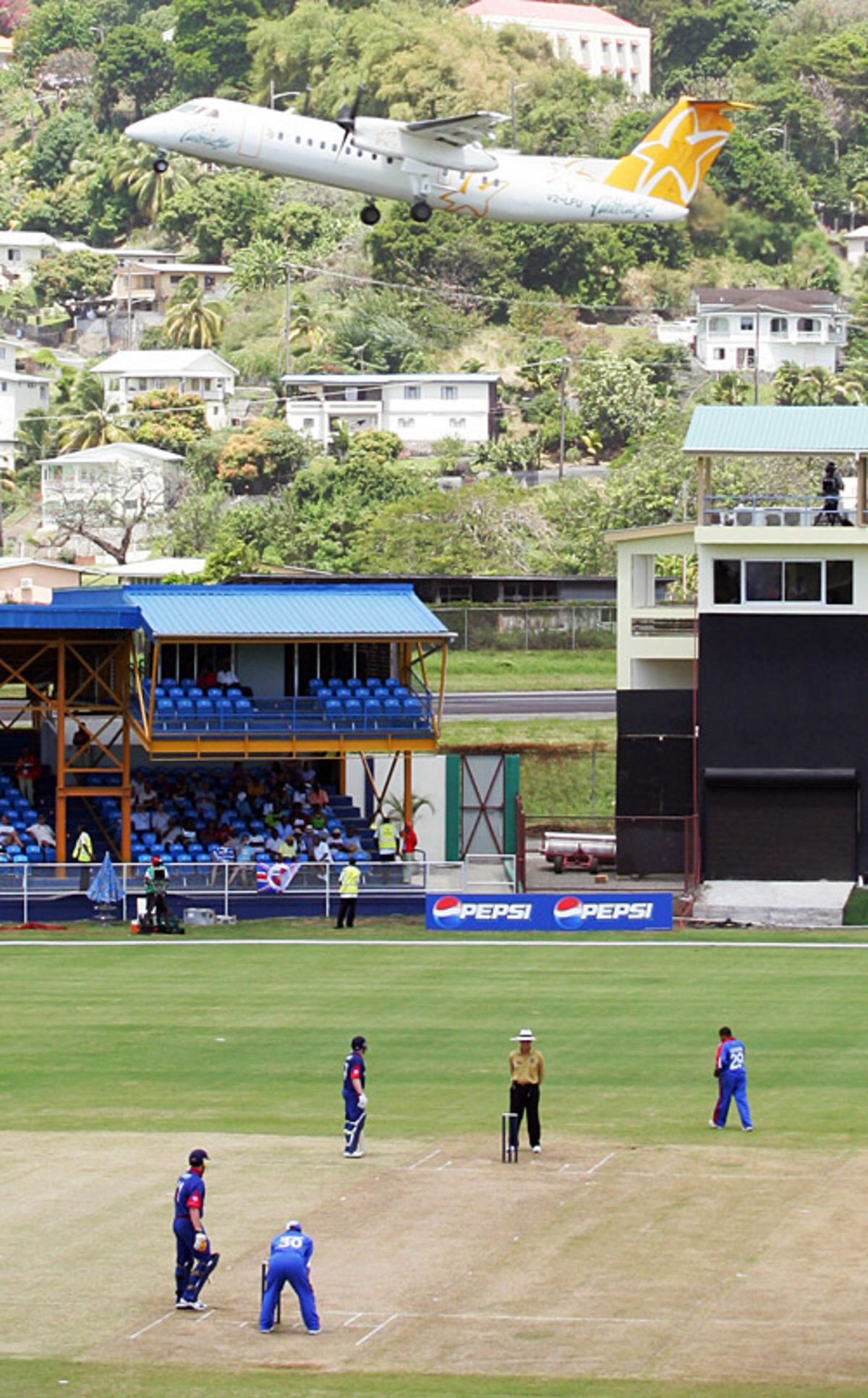 A plane takes off from E.T. Joshua Airport adjacent to the Arnos Vale ...