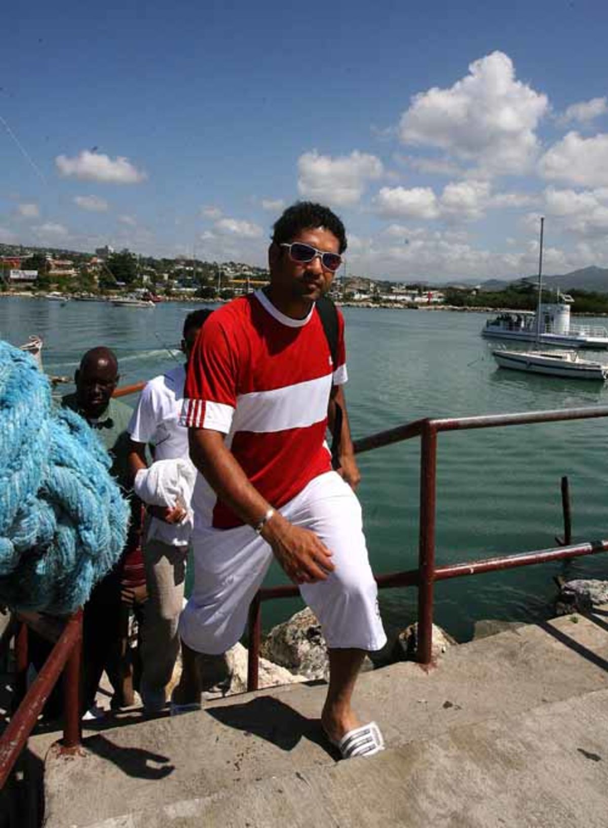 A fan poses next to a life size model of Sachin Tendulkar ...