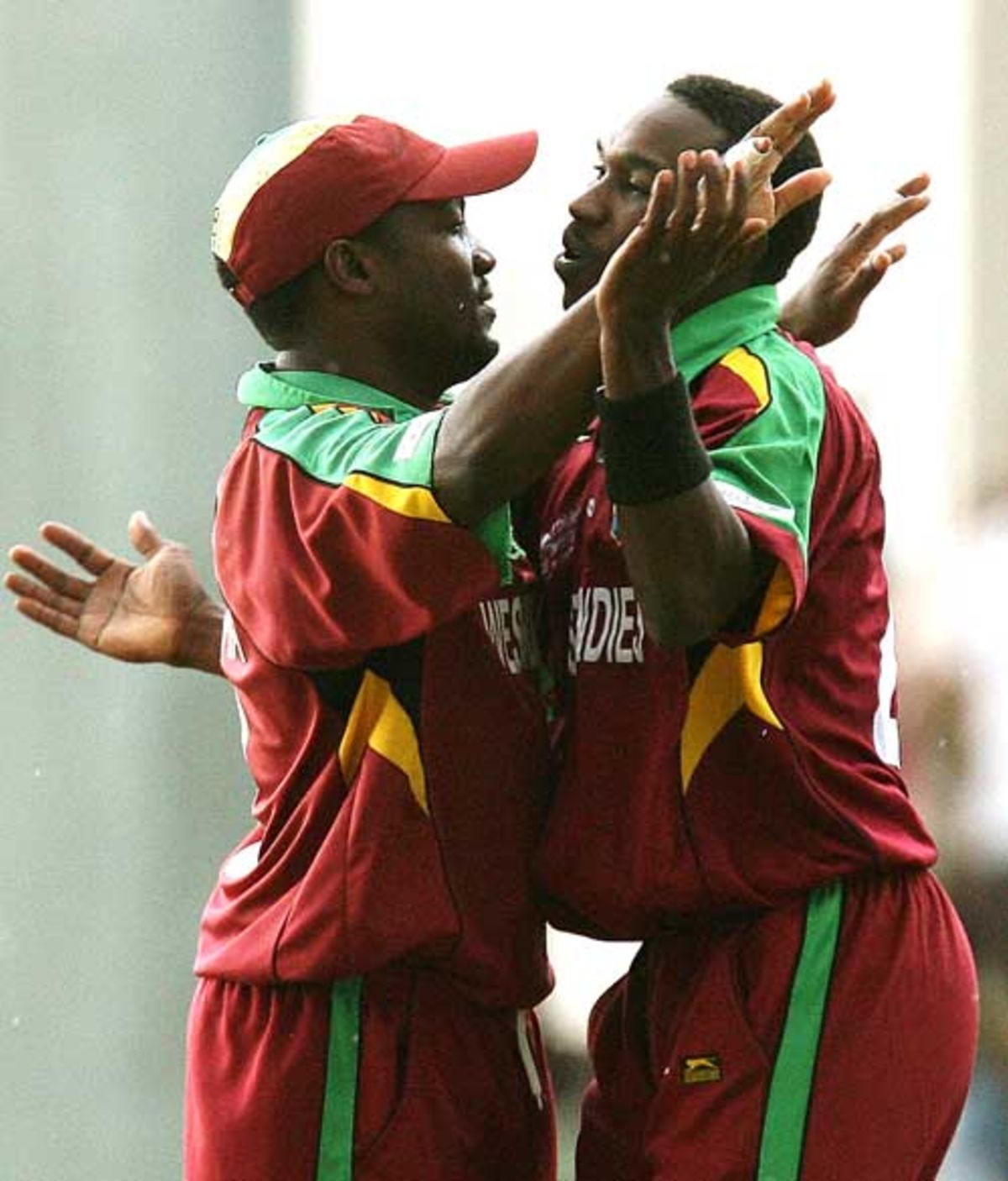 Brian Lara is congratulated by Dwayne Bravo after the run-out of ...