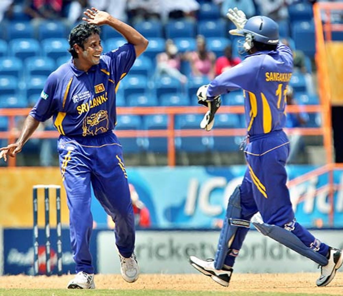 Chaminda Vaas and Kumar Sangakkara celebrate the dismissal of Peter ...