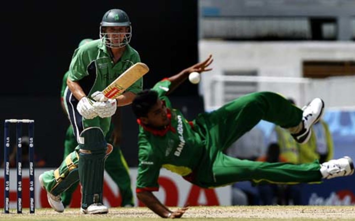 Mashrafe Mortaza dives in vain to stop a drive by William Porterfield ...