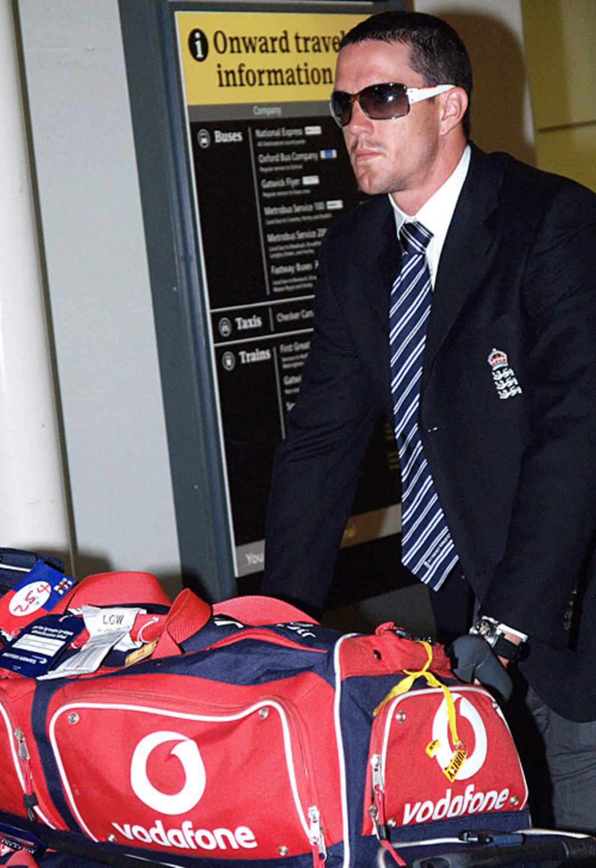 Peter Moores poses for photos behind a smoked screen of the three lions ...