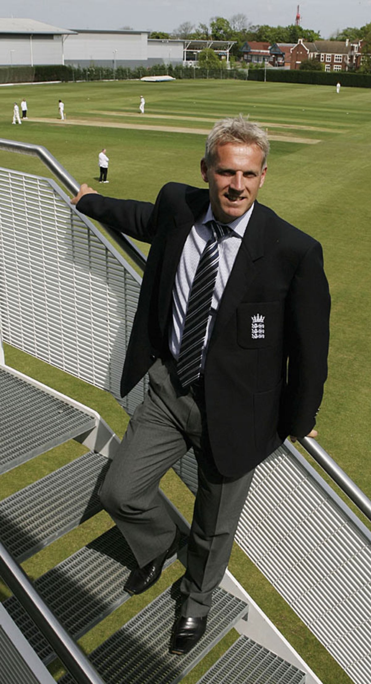 Peter Moores poses for photos behind a smoked screen of the three lions ...