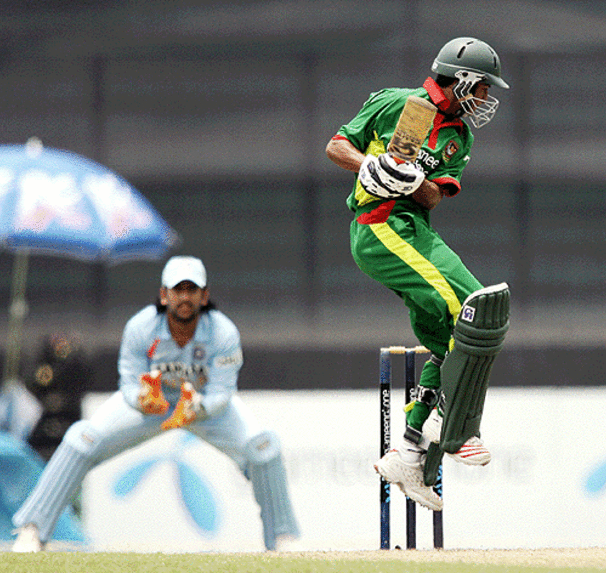 Javed Omar heads back to the pavilion after top-scoring for Bangladesh ...