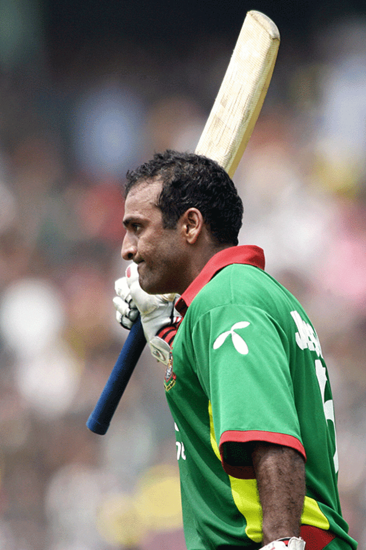 Javed Omar heads back to the pavilion after top-scoring for Bangladesh ...