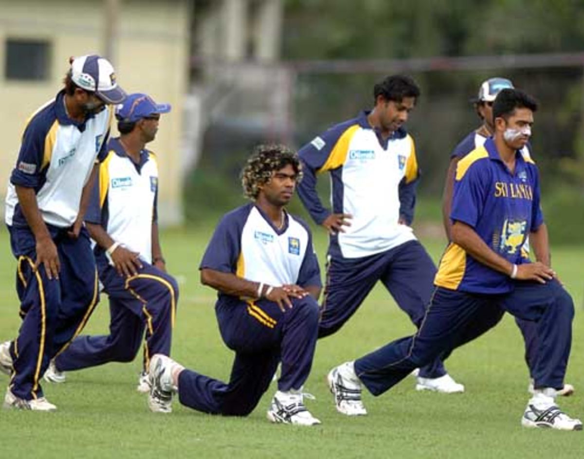 Sri Lankan cricketers warm up during a practice session ahead of their ...