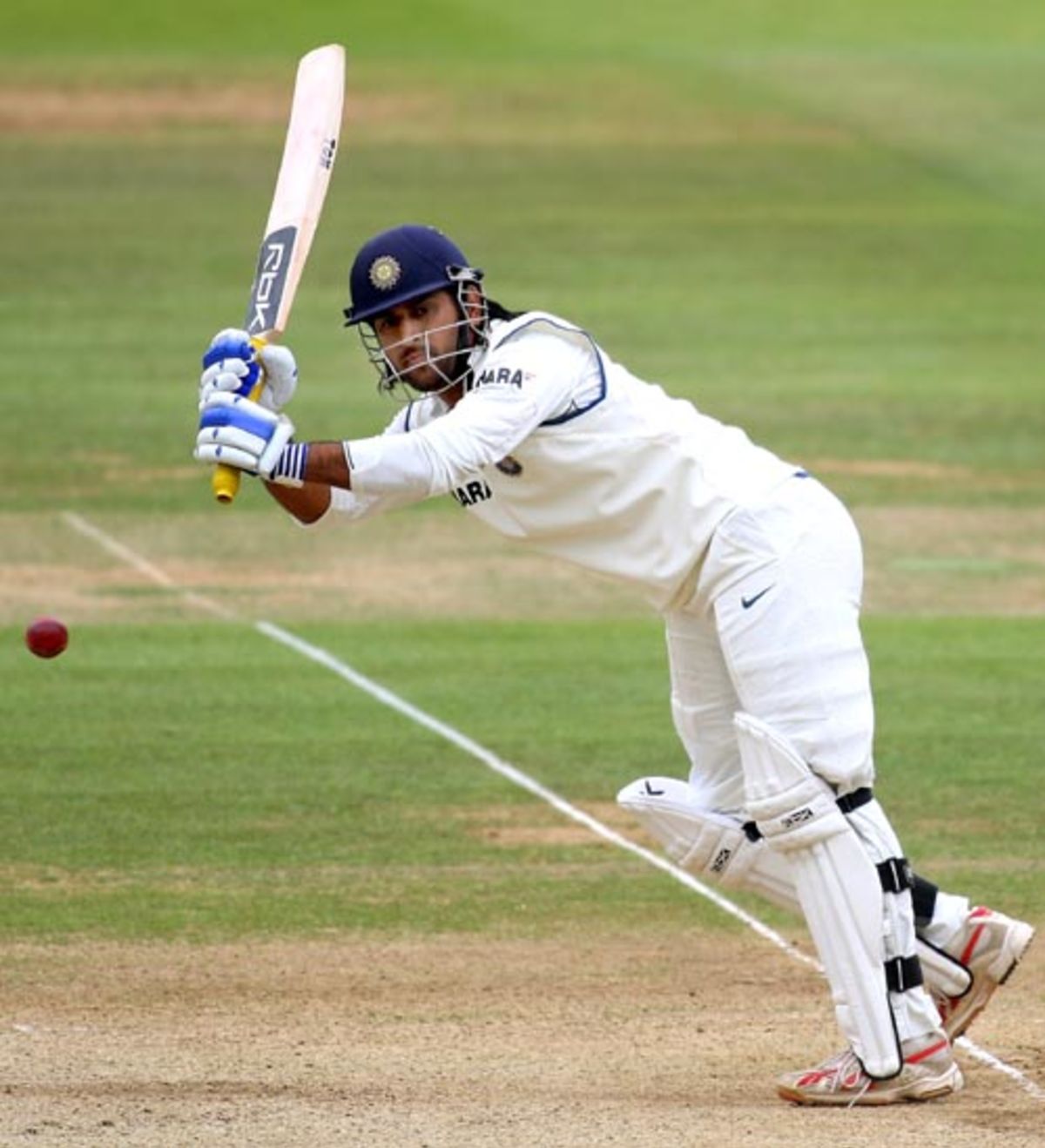 Andrew Strauss watches the ball speed to the boundary, while VVS Laxman ...