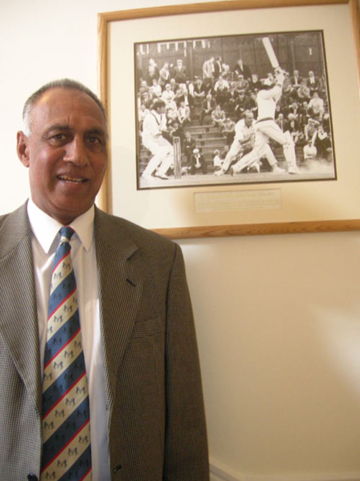 Basher Hassan stands in front of a Garry Sobers picture | ESPNcricinfo.com