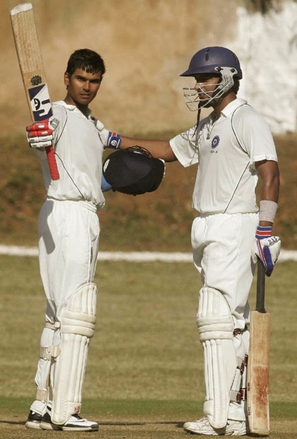 Subramaniath Badrinath is congratulated by Arjun Yadav on his hundred ...