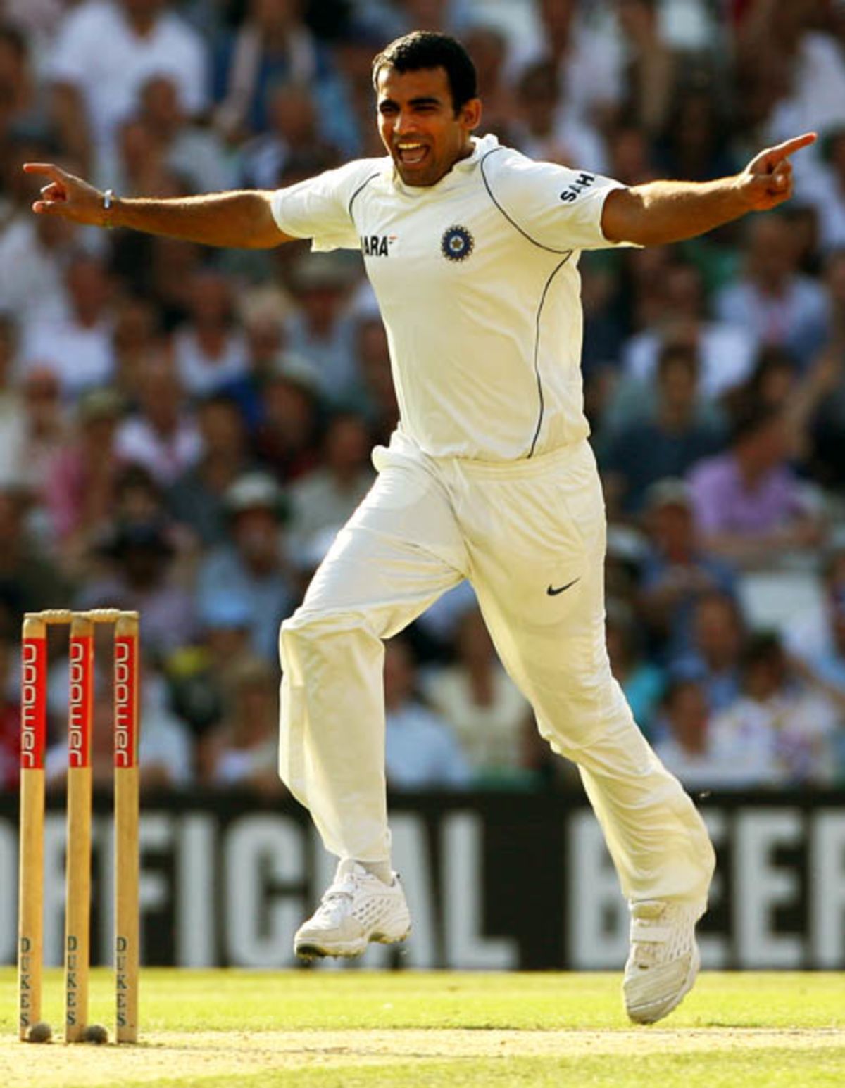Zaheer Khan, arms outsretched, celebrates the wicket of Ian Bell ...