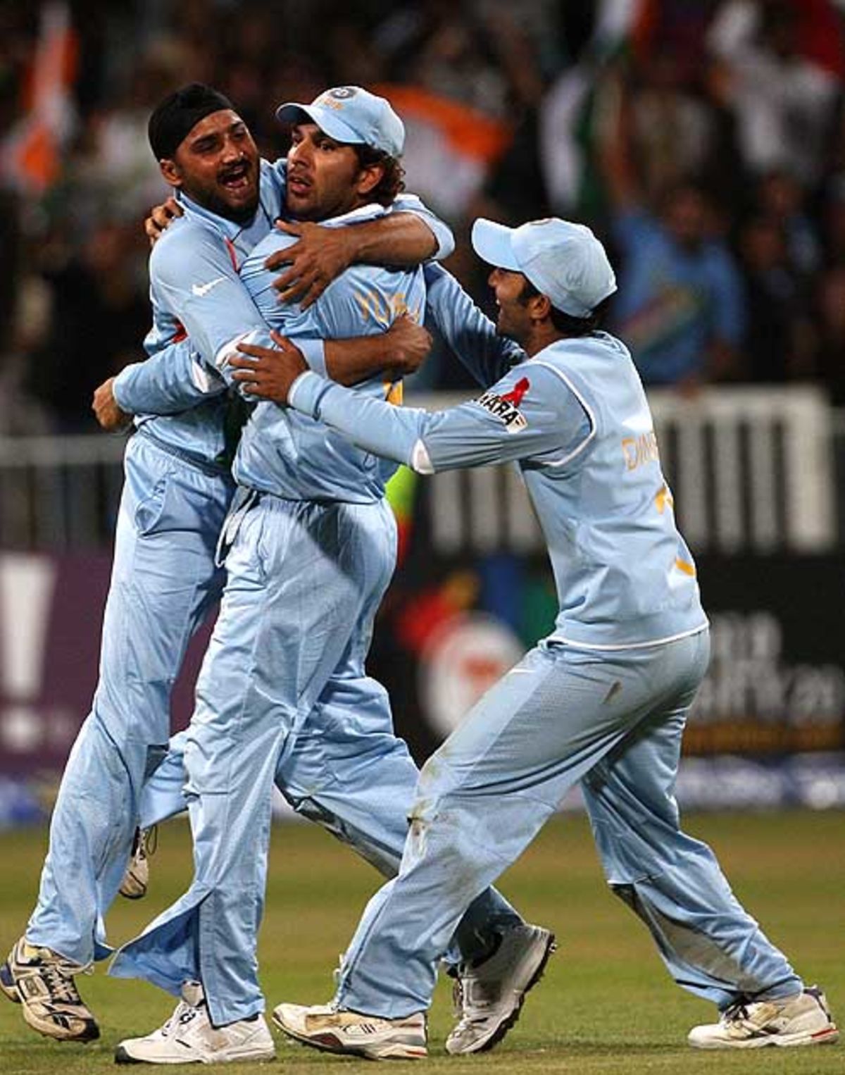 The Indian players are delighted after a run-out ensures the match is ...