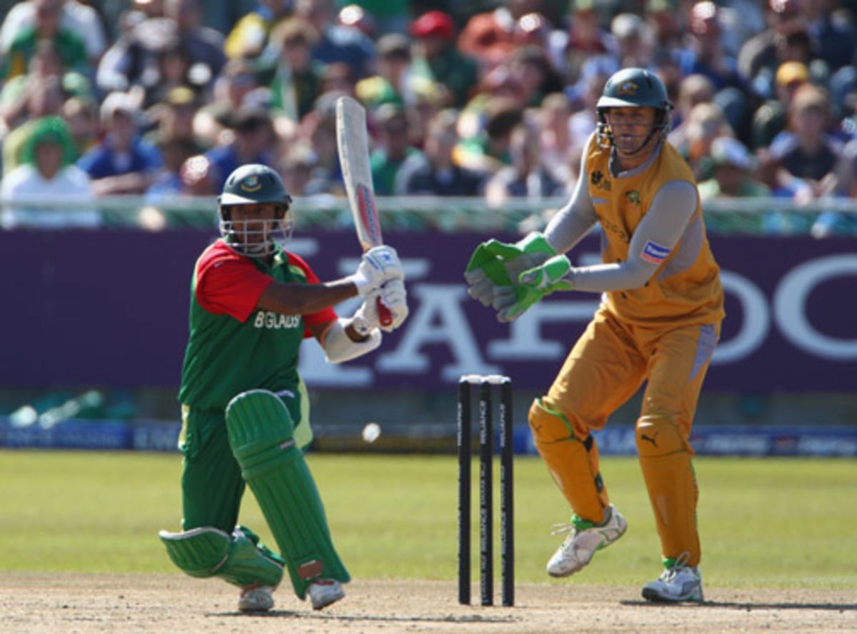Aftab Ahmed swings the ball through midwicket while Adam Gilchrist ...