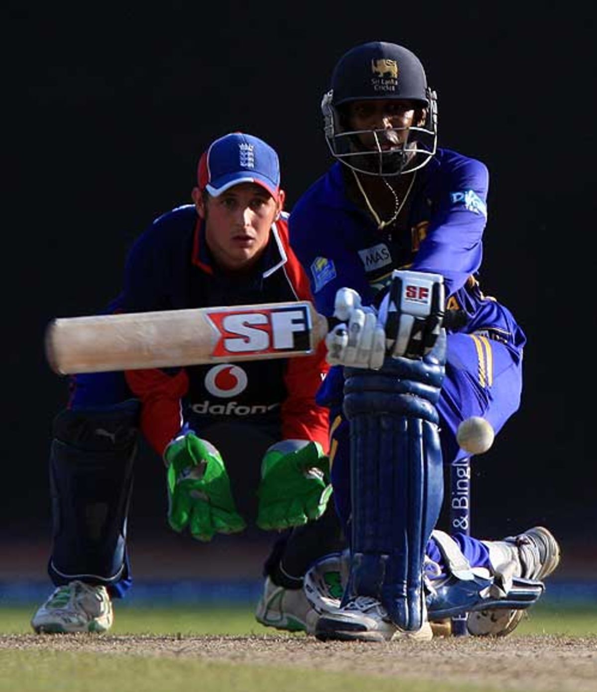 Chamara Silva gets into position to drive, as Phil Mustard looks on ...