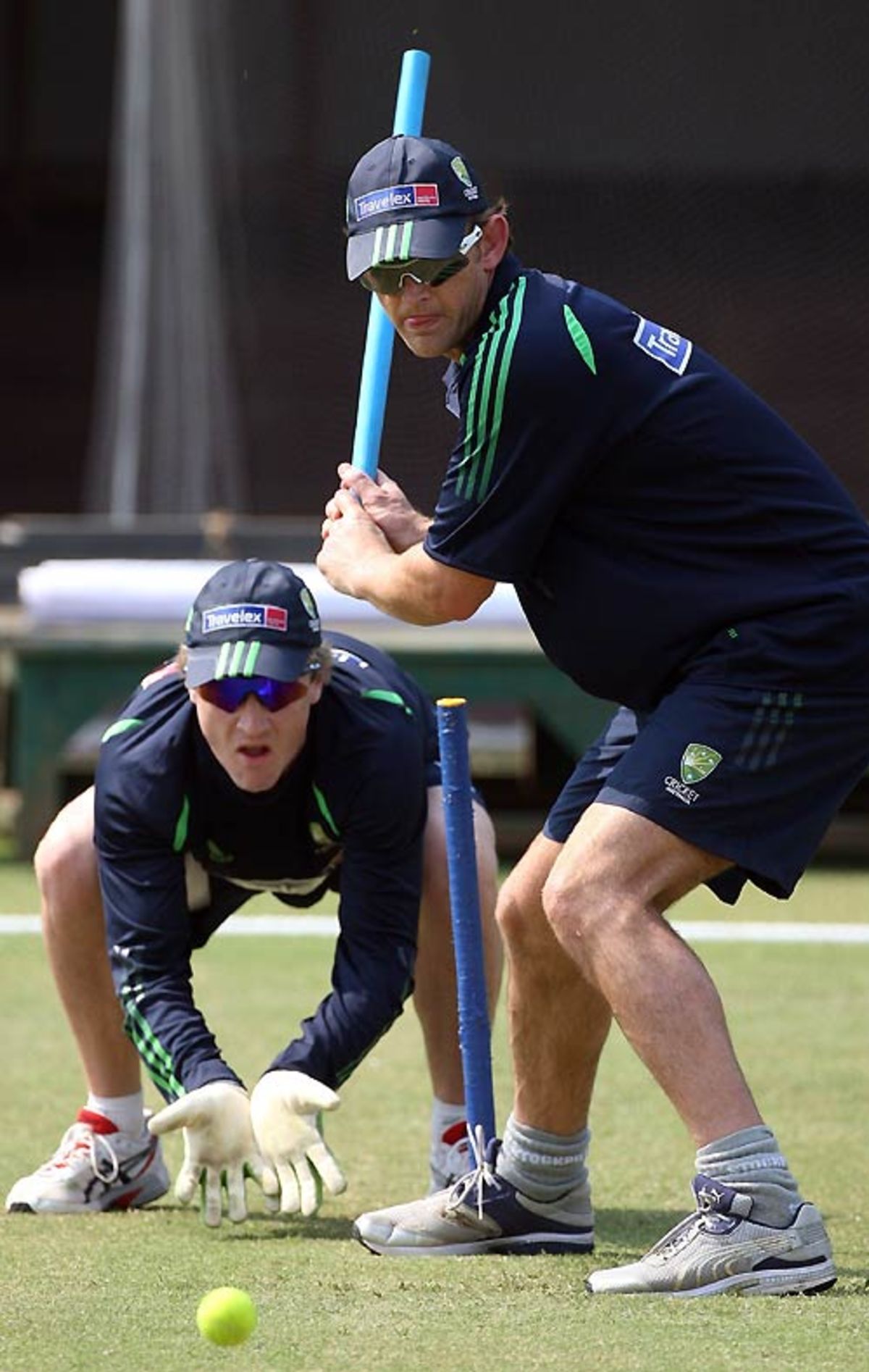 Adam Gilchrist bats with a stump while Brad Haddin looks on ...