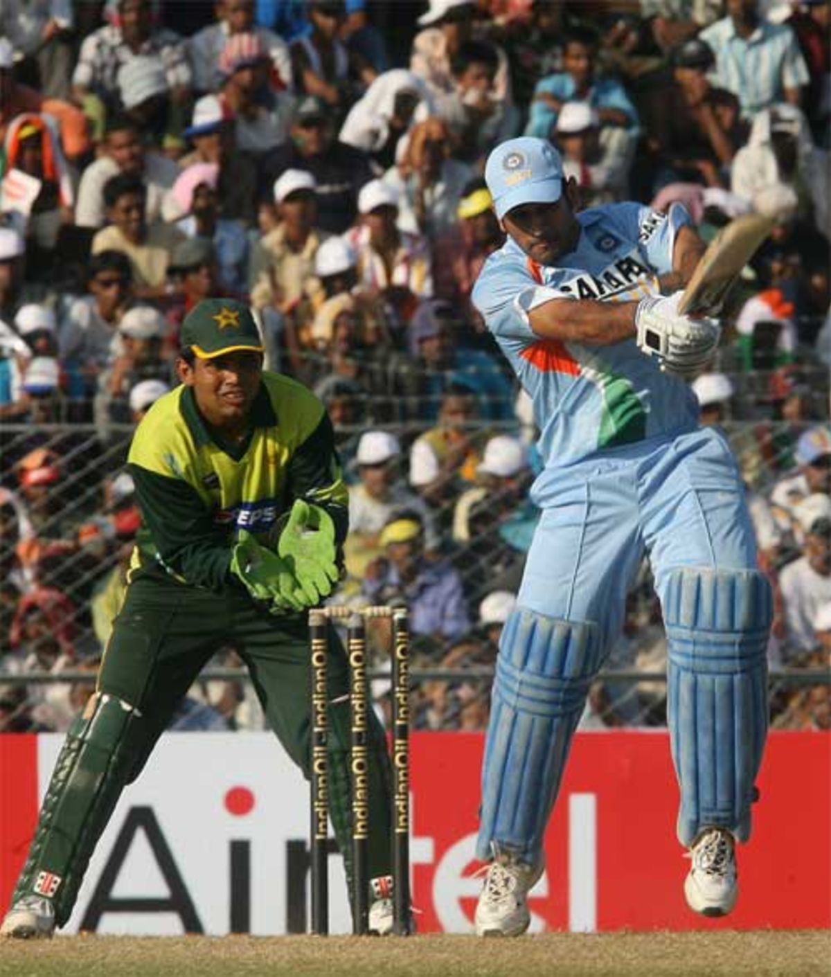 MS Dhoni acknowledges the applause after reaching his half-century ...