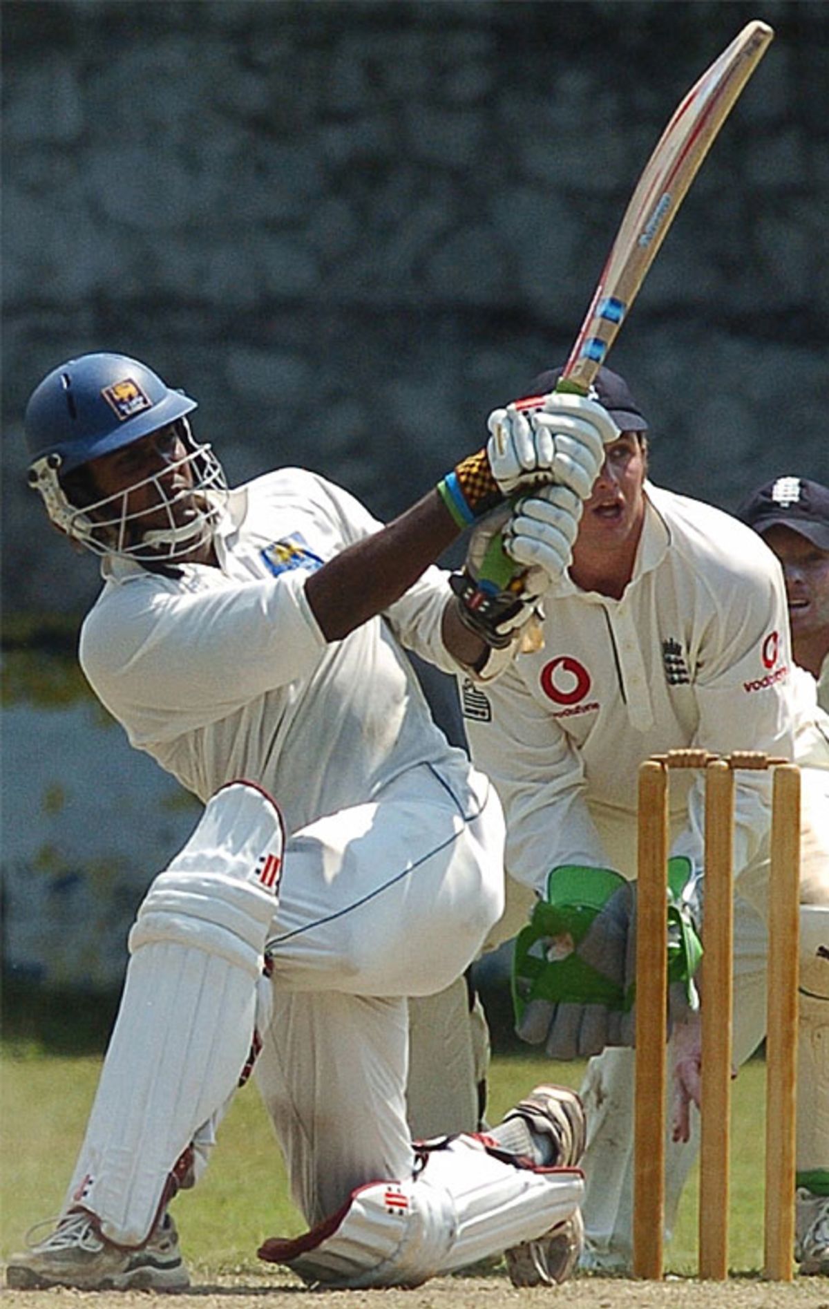 Chamara Kapugedera raises his bat after reaching his hundred ...