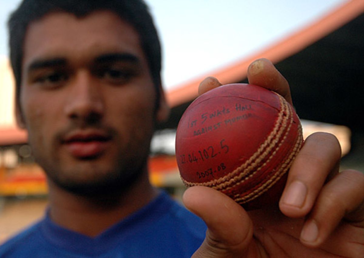 Delhi's Pradeep Sangwan proudly shows off the ball with which he took a ...