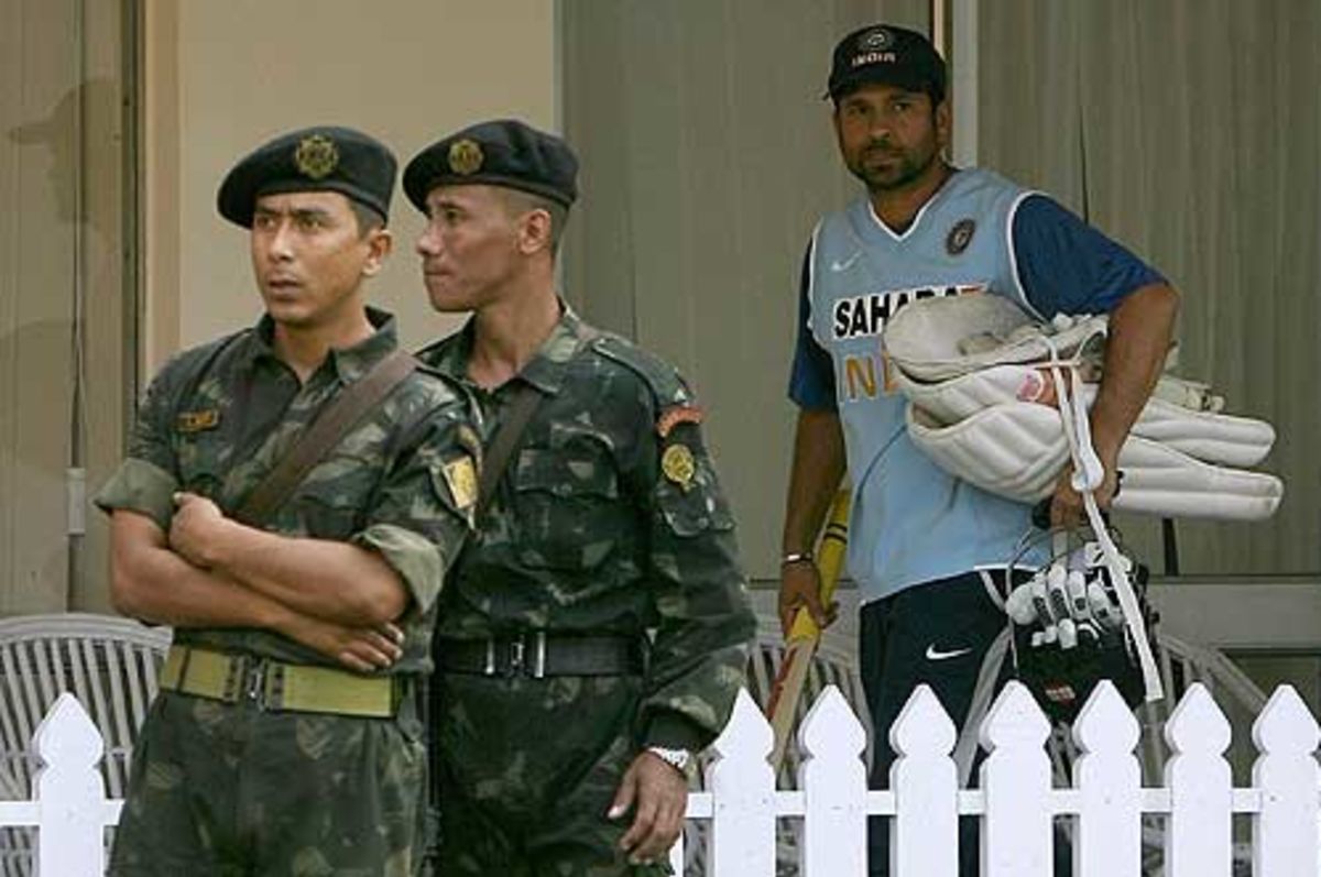 Sachin Tendulkar looks on as security personnel guard India's training ...