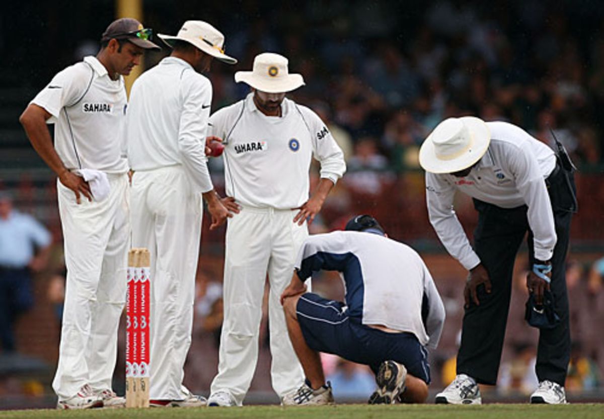 Members of the groundstaff take a look at the pitch | ESPNcricinfo.com