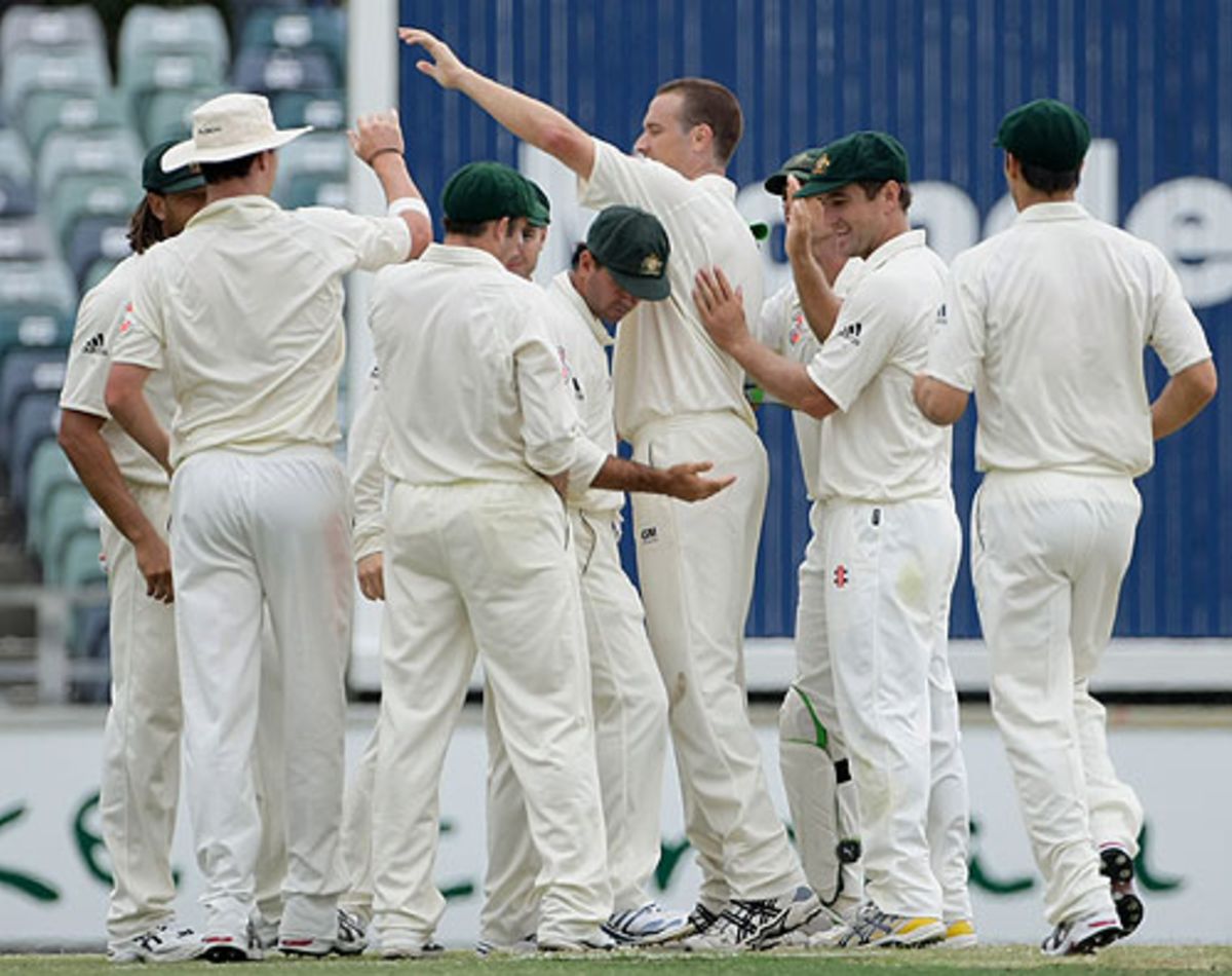Stuart Clark gets the high-fives after dismissing Virender Sehwag ...