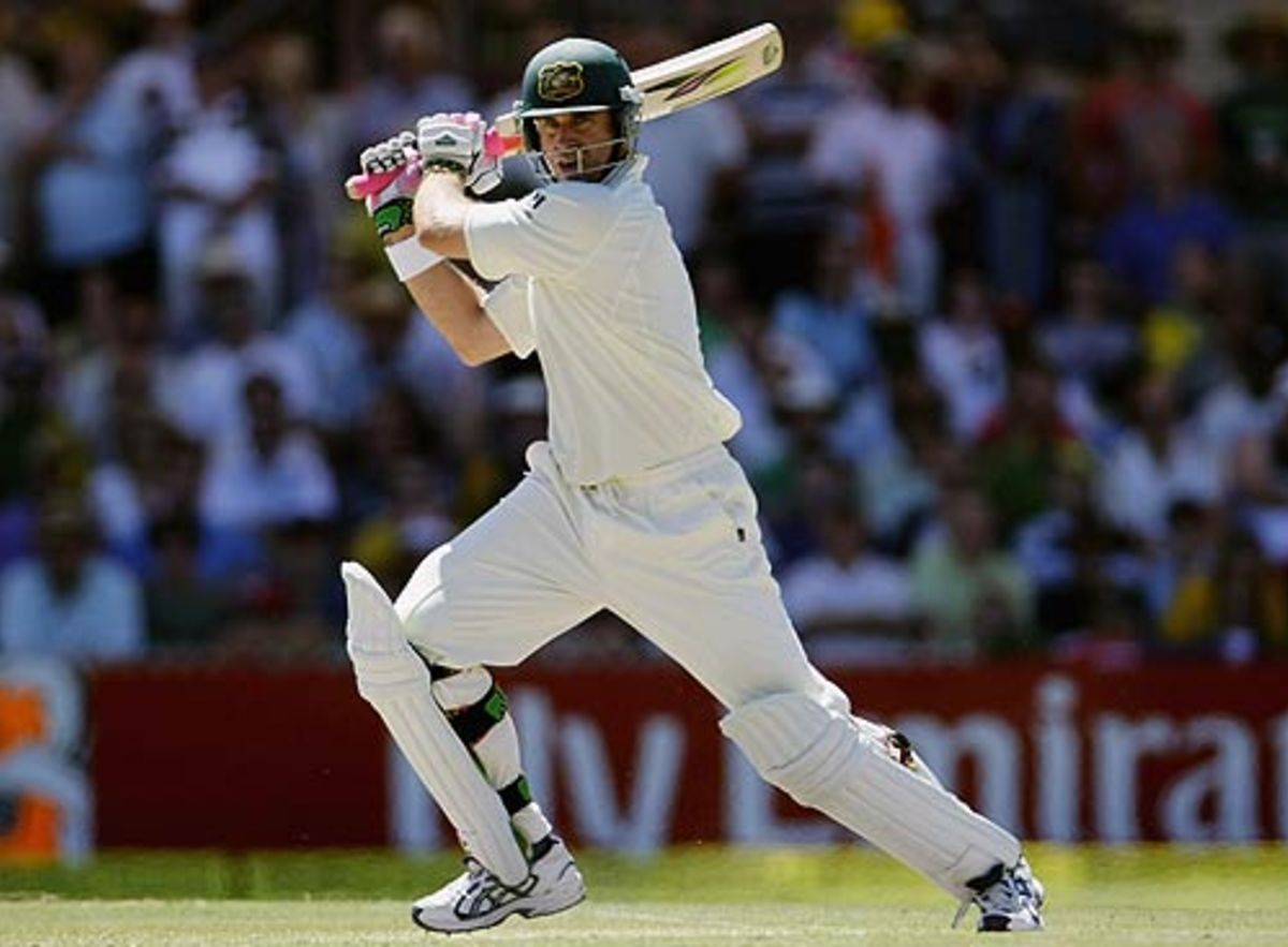 Matthew Hayden raises his bat after reaching his half-century ...