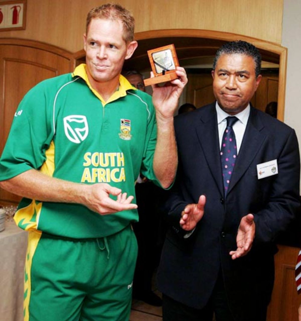 Shaun Pollock displays a medallion as Cricket South Africa president Norman Arendse looks on ...