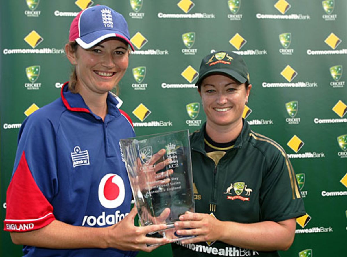 Charlotte Edwards and Karen Rolton hold the trophy shared by the two ...