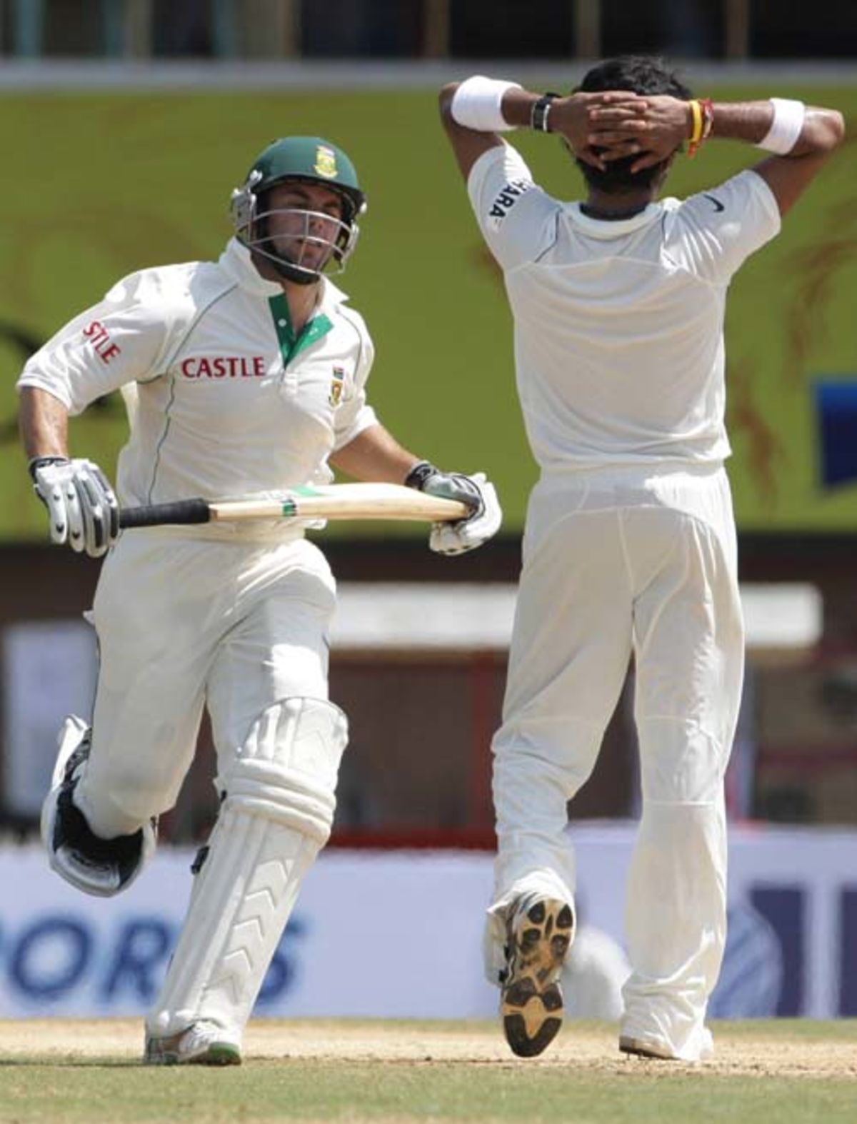 Neil McKenzie picks up a single while a frustrated Sreesanth looks on ...