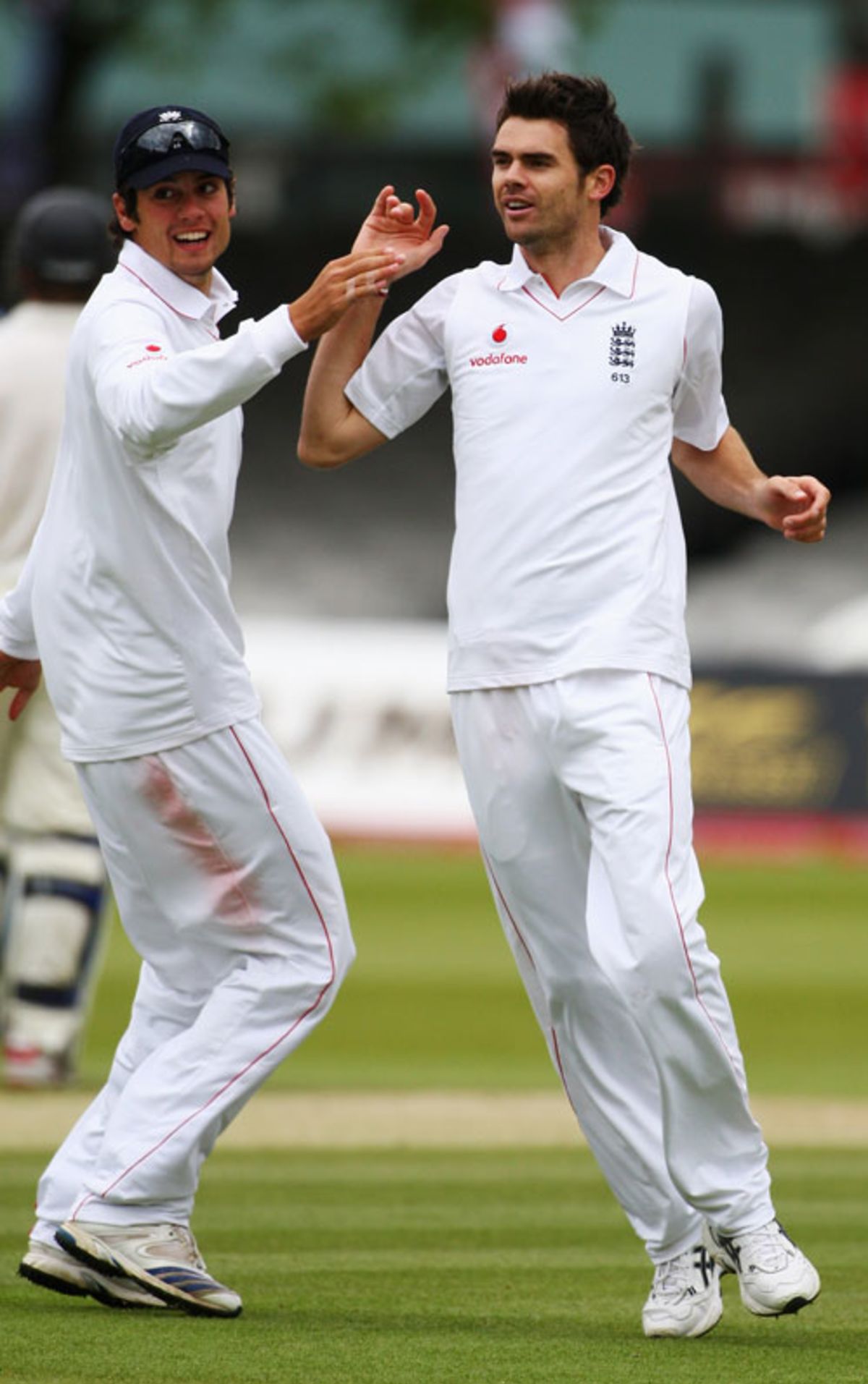 James Anderson and Alastair Cook celebrate the dismissal of Aaron ...