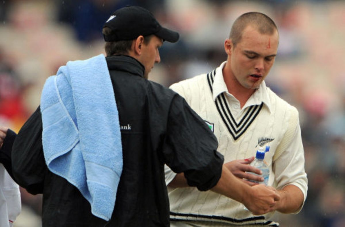 Daniel Flynn prepares to leave the field after sustaining a painful hit ...