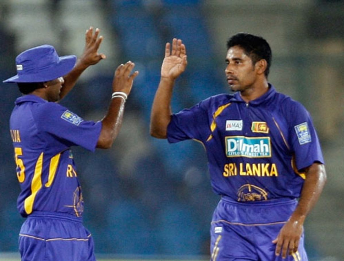 Chaminda Vaas celebrates with a team-mate after getting the first ...