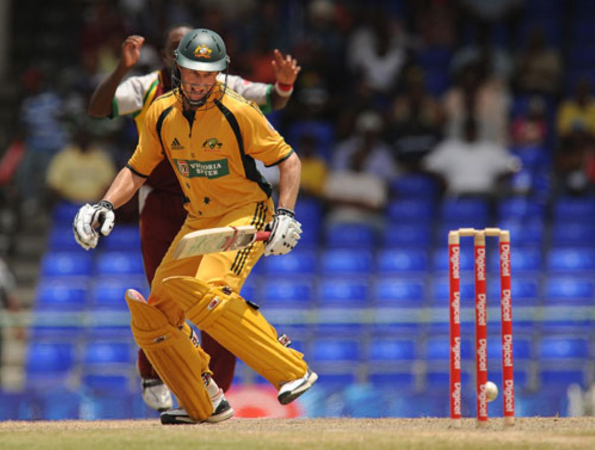 David Hussey watches as the ball crashes into the stumps without ...