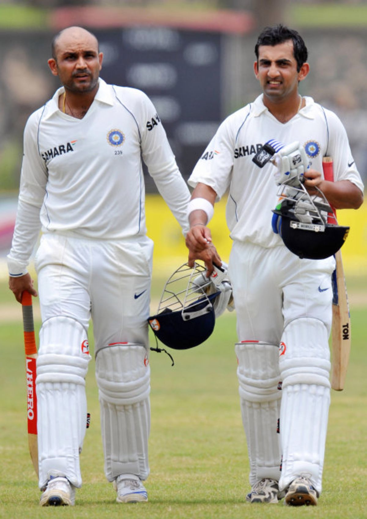 Virender Sehwag and Gautam Gambhir return to the pavilion after putting on 151 runs before lunch ...